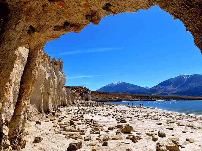 Peering through this natural stone archway frames mountains and lake in a view worth framing itself.