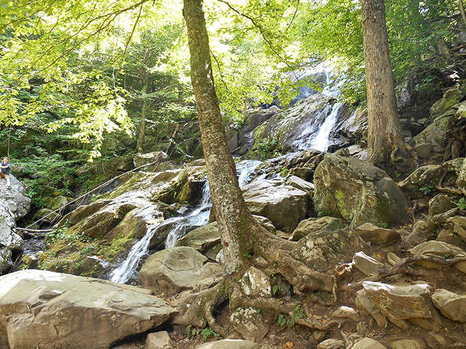 Massive boulders frame multiple levels of flowing water, each cascade adding its own voice to the symphony.