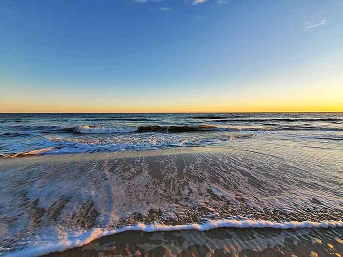 Golden hour transforms the surf into liquid amber, proving that the best shows in life are absolutely free.