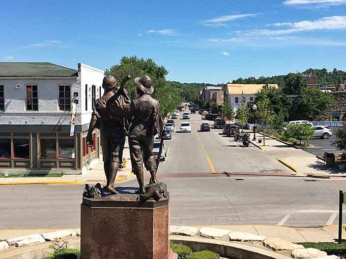 Tom and Huck's bronze figures survey Hannibal's main street with the confident swagger of two kids who know they own this town.