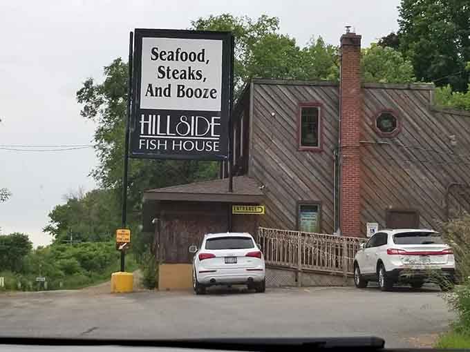 Tucked behind summer greenery, Hillside Fish House's weathered wood exterior whispers "the good stuff is always worth finding."