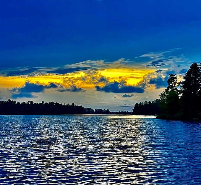 That golden band of clouds blazing over the lake looks less like a sunset and more like pure magic.