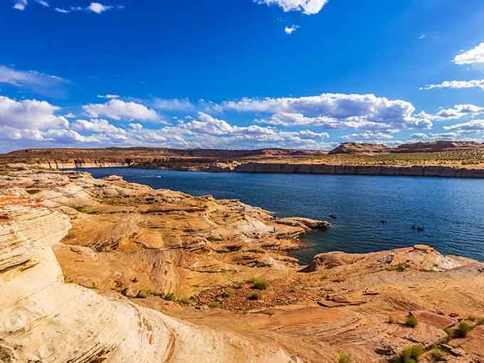 Golden sandstone shelves meet deep blue water at Lake Powell, a geological masterpiece hiding in plain sight.