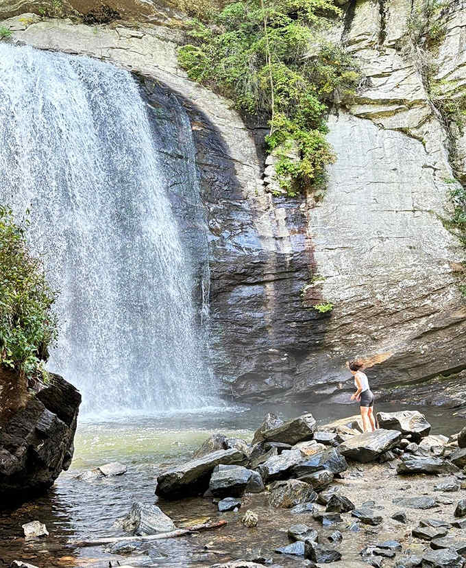 Standing at the base of that thundering curtain of water, even the bravest visitor looks wonderfully small.