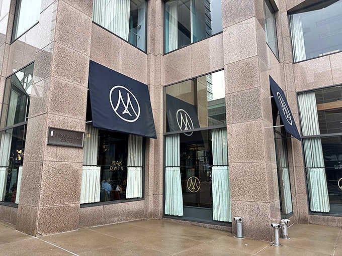 Three matching awnings wrapped around granite stone corners, Max Downtown means business from every angle.