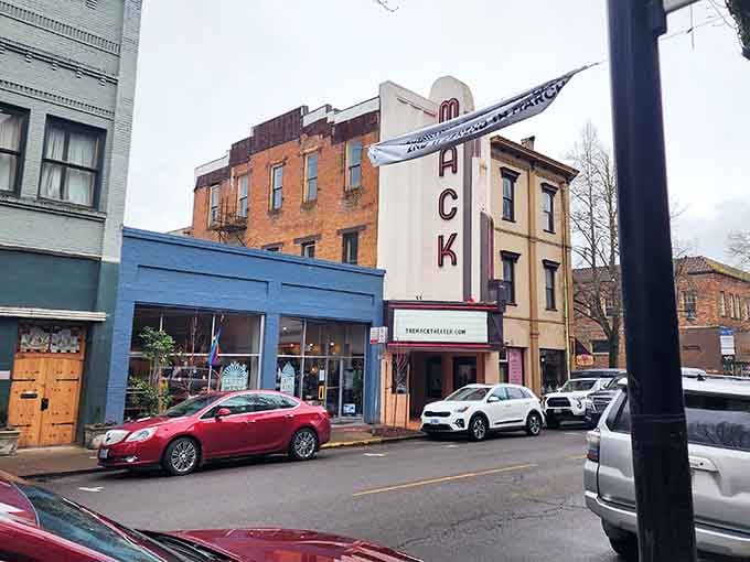 The Mack Theater marquee anchors McMinnville's downtown like a beloved neighbor who always knows what's happening this weekend.