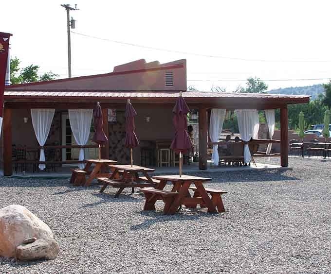Picnic tables, flowing curtains, and gravel underfoot &mdash; Oak Creek's patio has a relaxed charm that's hard to resist.
