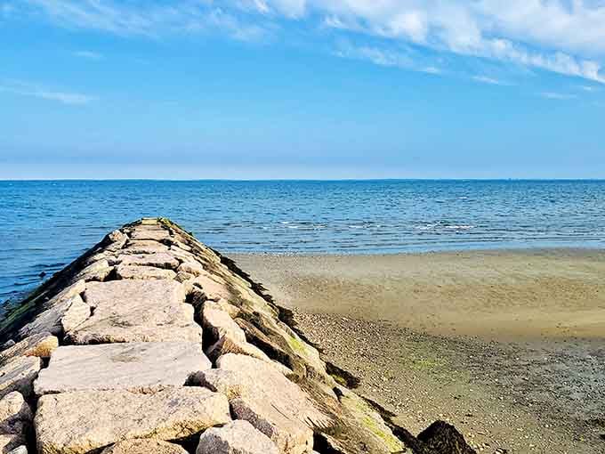 This mossy stone jetty at Silver Sands points straight toward the horizon like a very determined compass needle.