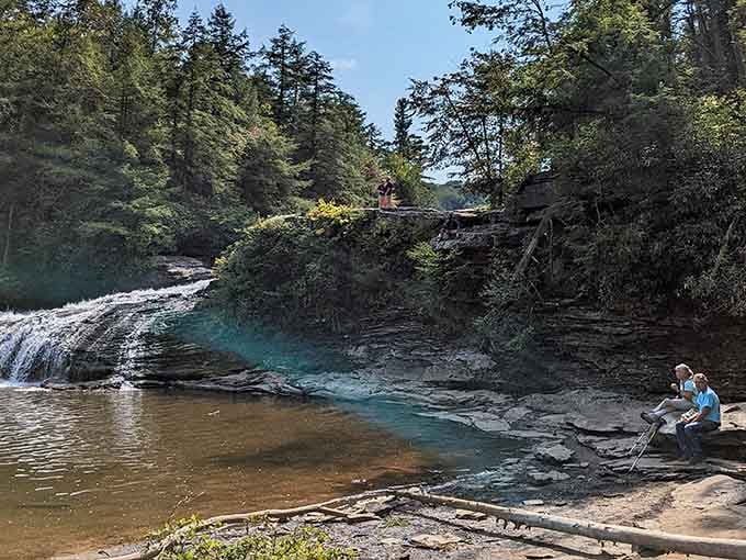 Crystal-clear water pools beside layered rock ledges at Swallow Falls, the kind of scene that makes you forget your phone exists.