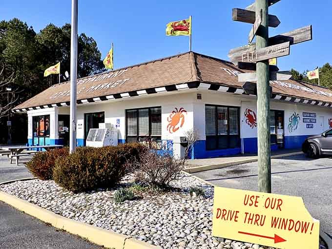 A bright yellow "Use Our Drive Thru Window" sign outside a seafood shack is the greatest sentence ever written.