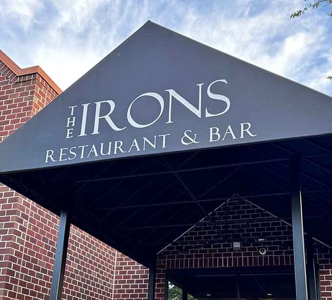 That sleek black awning against red brick whispers sophistication while the menu inside delivers pure coastal comfort food.