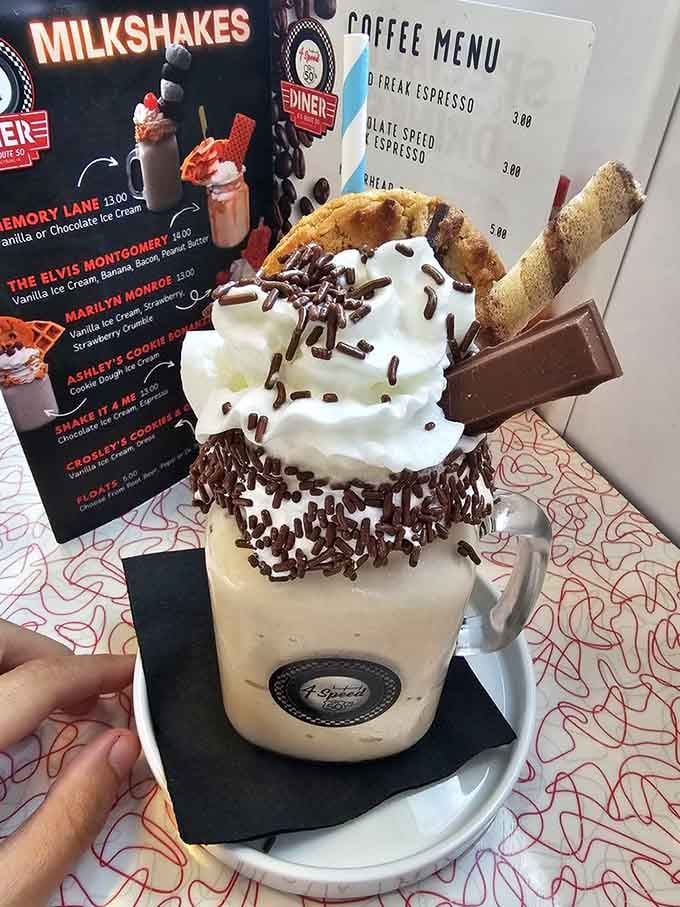 Towering whipped cream, chocolate sprinkles, and a KitKat on top. This milkshake didn't come to play around.