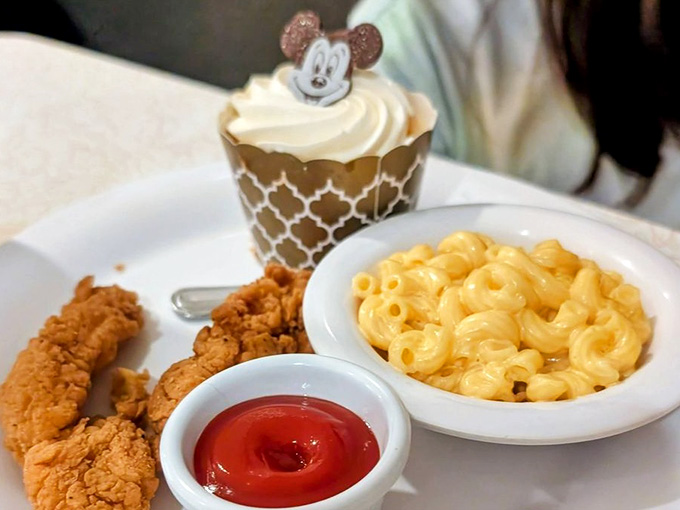 Chicken tenders, mac and cheese, and a Mickey cupcake. Honestly, the kids aren't the only ones ordering this.