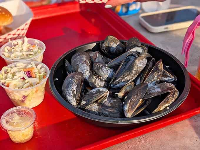 A heaping bowl of steamed mussels, glistening and ready, proof that the best things in life don't need a fancy plate.