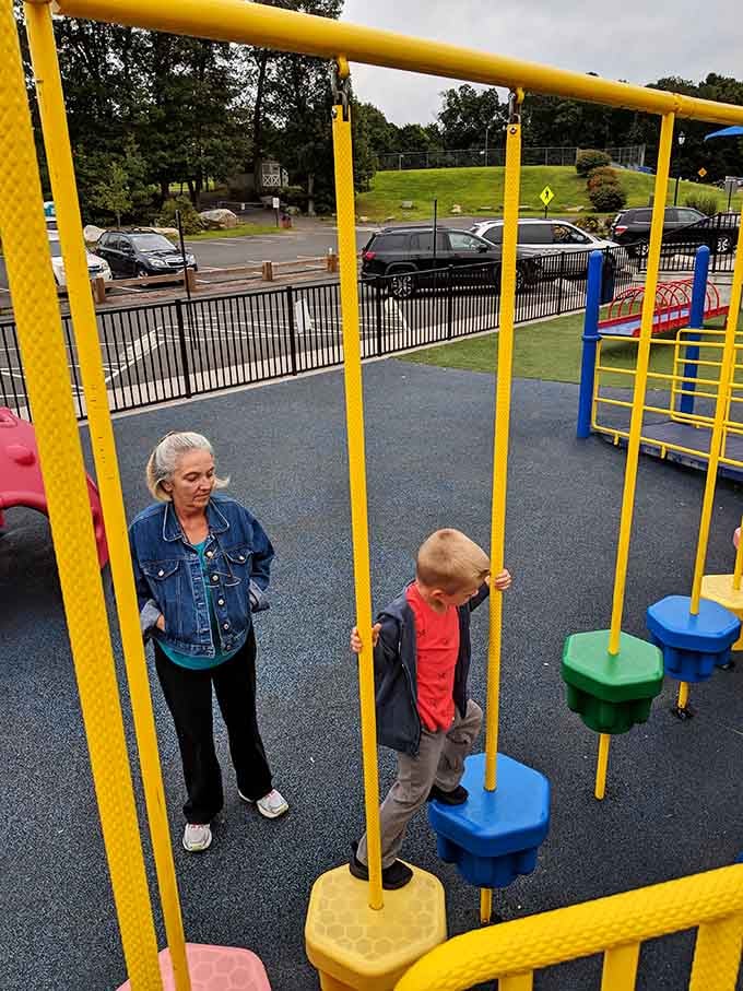 Grandma's keeping a close eye, but honestly, those colorful stepping platforms look pretty tempting for everyone involved.