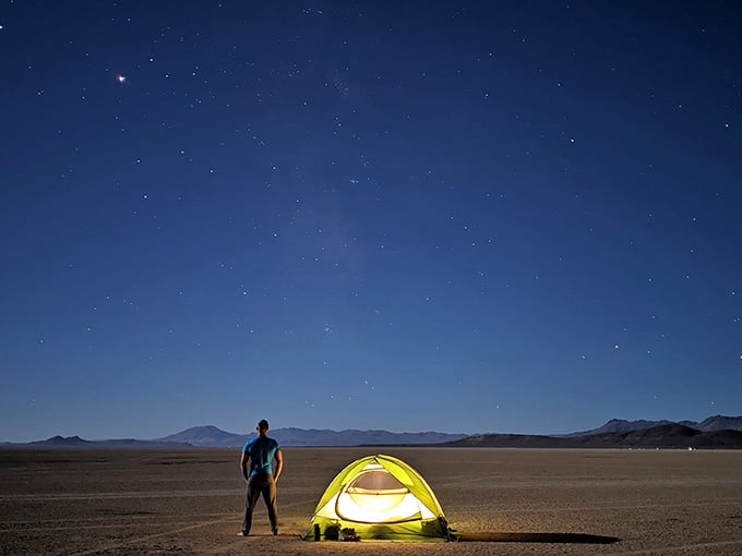 Under stars so bright they seem fake, your tent glows like a beacon for wanderers who chose wilderness over Wi-Fi.