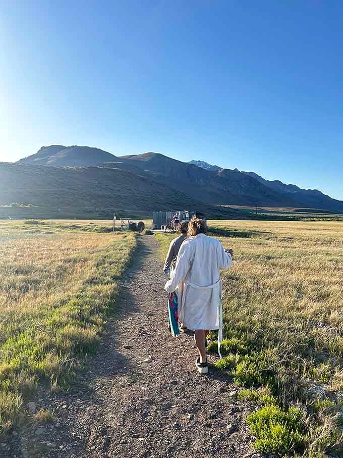 The universal bathrobe walk, because nothing says "I've made excellent life choices" quite like heading to a hot spring at dawn.