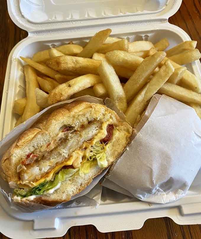 That golden, loaded fish sandwich with a mountain of fries is the kind of lunch that makes the afternoon feel manageable.