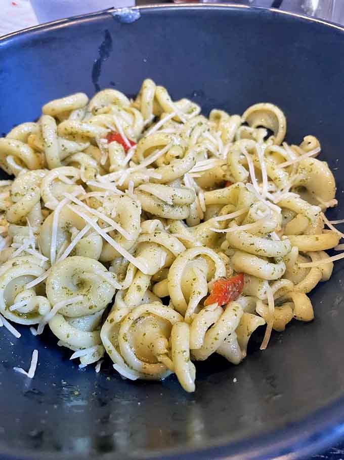 Pesto pasta that looks like it was tossed together with real care, the kind of bowl that makes you forget everything else on the table.