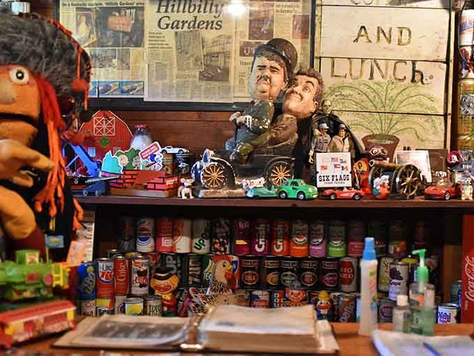 Laurel and Hardy figurines surrounded by vintage soda cans, because why not mix comedy legends with cola history.