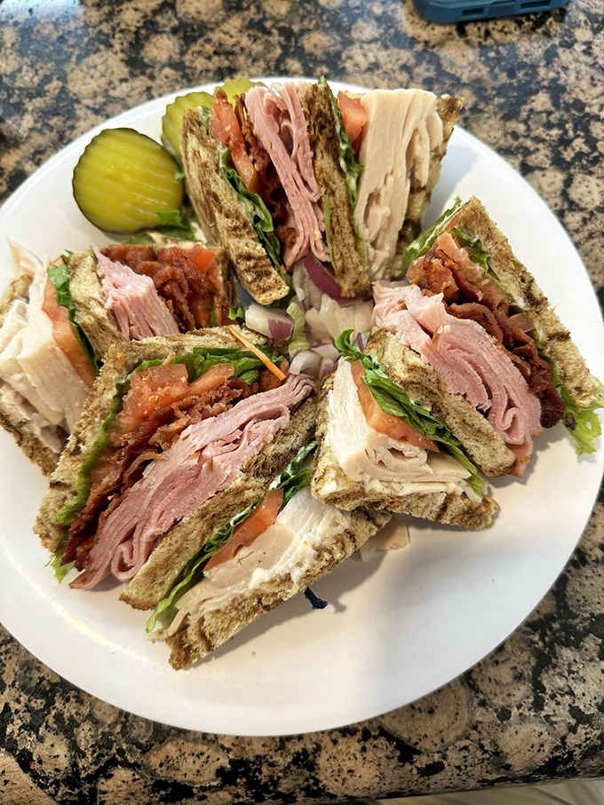 A club sandwich stacked so generously it practically needs its own zip code. Pure, unapologetic deli joy.