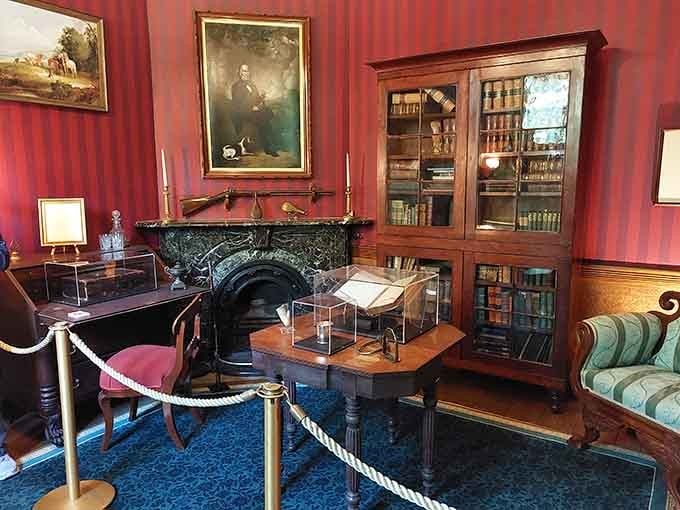 Bold red walls, a portrait watching over the room, and books that have seen more history than most people ever will.
