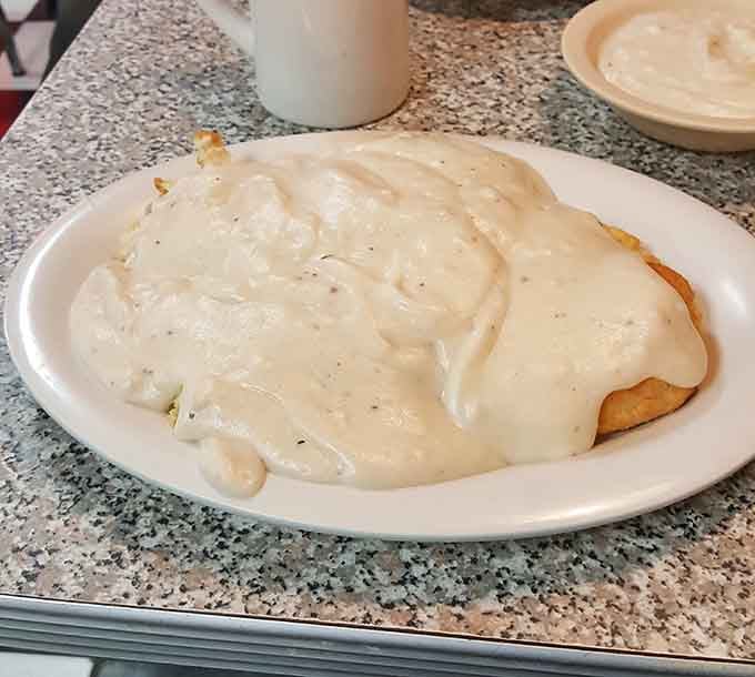 Biscuits and gravy so generously smothered, you'll need a moment just to appreciate the commitment.