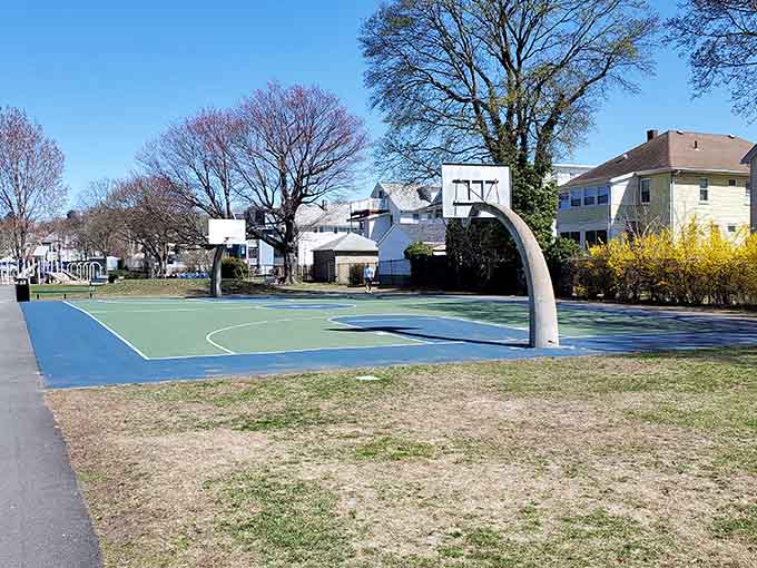 Public basketball courts where pickup games happen and nobody's checking their fantasy sports stats between possessions.