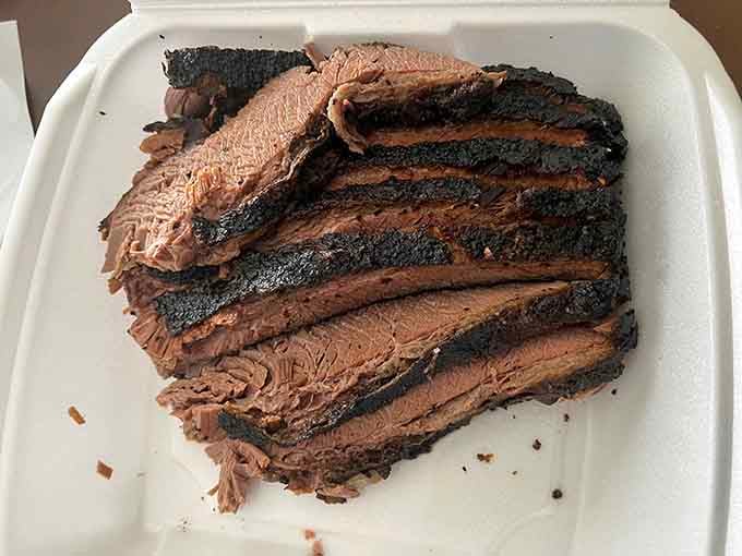 Twelve hours of hickory and oak smoking produces brisket with a bark this dark and beautiful.