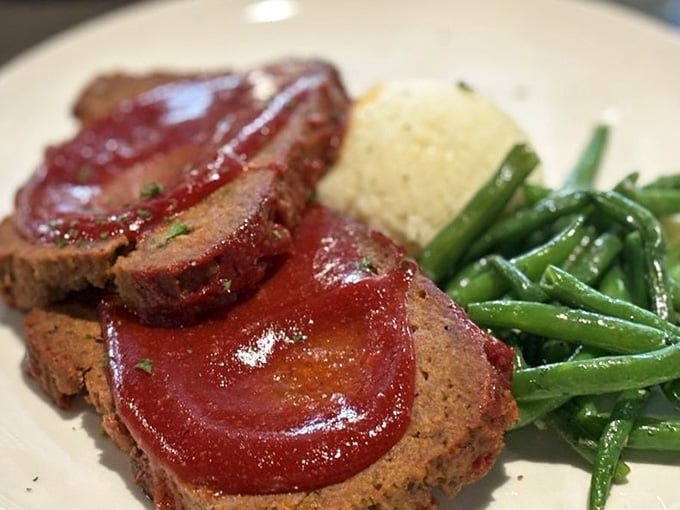 Meatloaf this good deserves a standing ovation. Glazed, sliced, and plated with green beans and whipped potatoes.