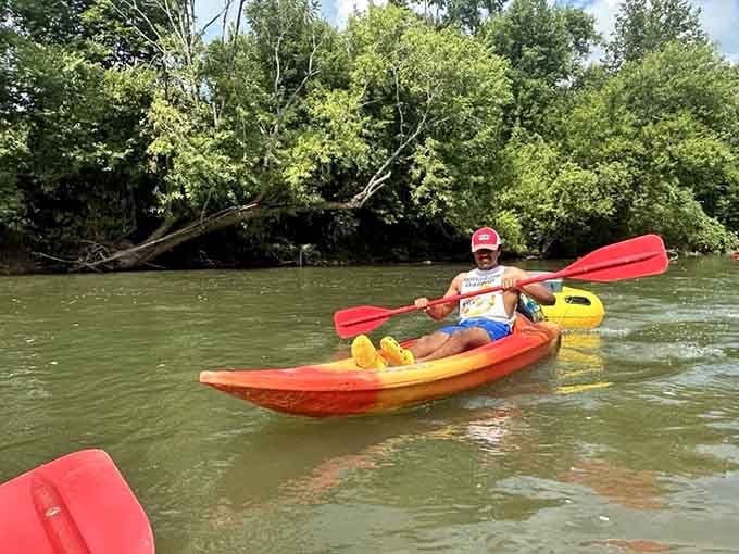 A paddler navigating Blue Springs Creek with the confidence of someone who made an excellent life decision today.