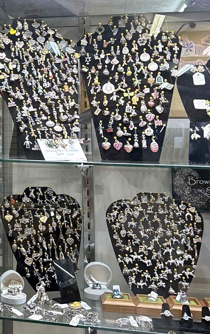 Rows of sterling silver charms behind glass, tiny treasures that somehow make you feel like a kid in a candy store.