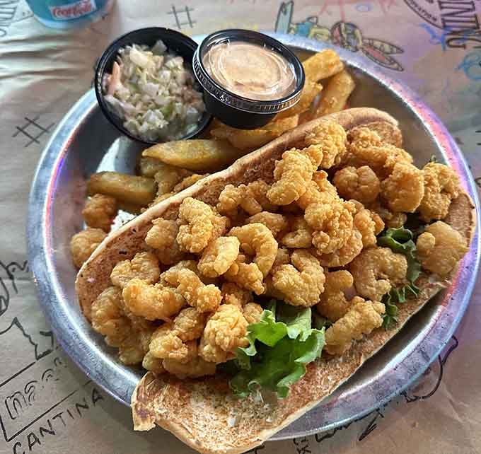 That golden, crispy fried shrimp po-boy is piled so high it's practically a structural engineering achievement.