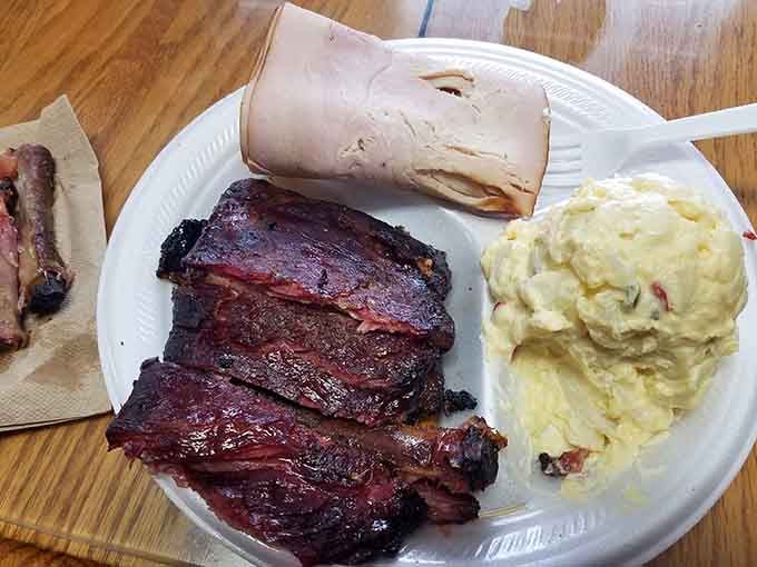 Smoky ribs, sliced pit ham, and creamy potato salad sharing one plate, that's not a meal, that's a reunion.