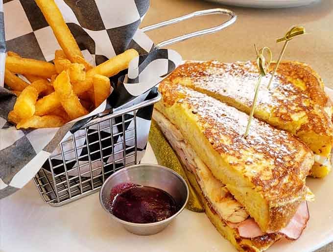 The Monte Cristo arrives dusted with powdered sugar like it's ready for its close-up, fries standing at attention.