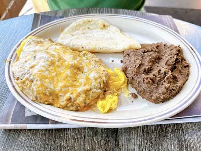 A cheesy, golden omelette with refried beans and tortillas. This plate is having a very good morning indeed.