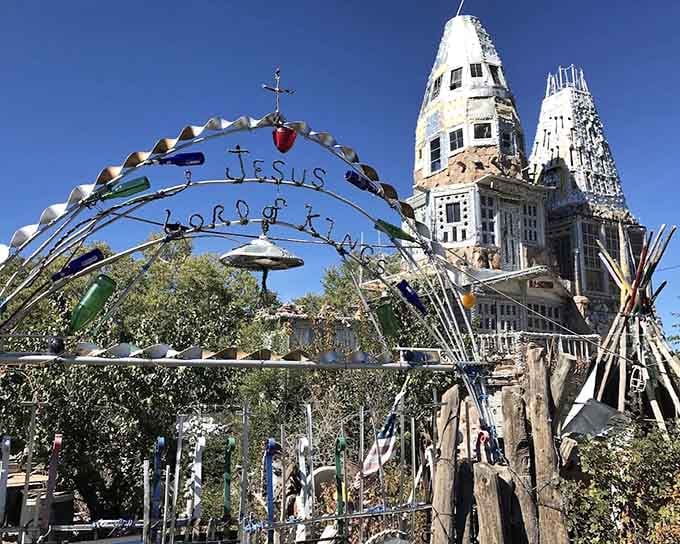 A handmade archway reading "Jesus Lord of Kings" welcomes you, colored glass bottles and all, into something truly sacred and strange.