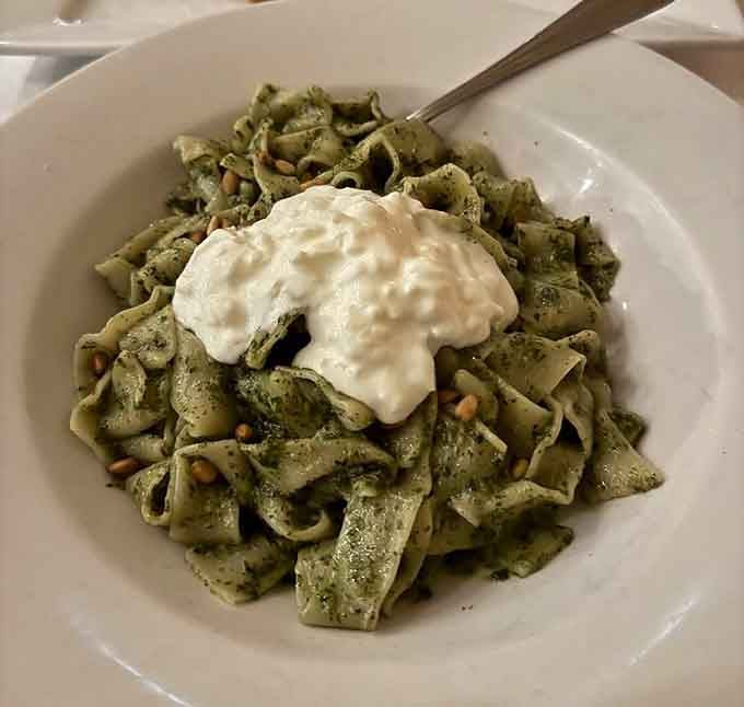 House-made pappardelle tossed in basil pesto, scattered with pine nuts, and finished with a cloud of creamy burrata on top. Yes, really.