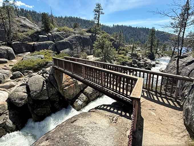 This footbridge marks your progress toward paradise, spanning the river like nature's own welcome mat to adventure.