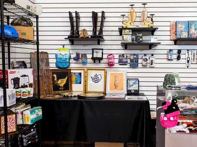 Framed art, tall boots, knick-knacks, and coffee makers all sharing one shelf, and somehow it works perfectly.