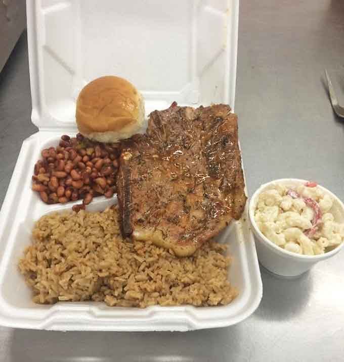 A grilled pork chop with rice, beans, macaroni salad, and a roll. Lunch doesn't get more honest.