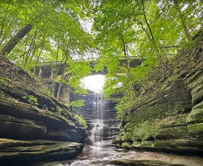 That stone arch bridge overhead makes the whole canyon feel like a scene from an old adventure novel.