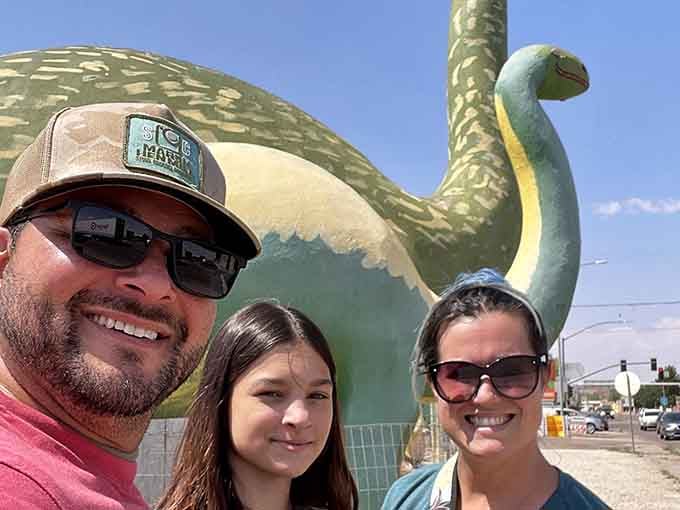 The only family photo worth framing this year involves a giant concrete dinosaur photobombing everyone.