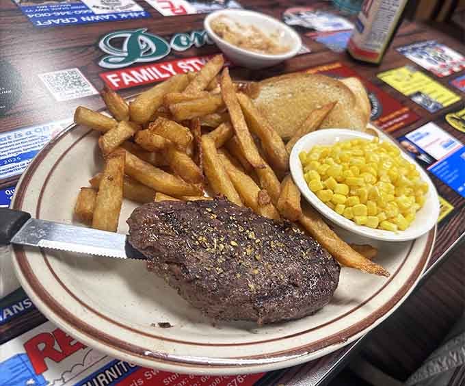 A seasoned chopped steak with fresh-cut fries and sweet corn, simple, confident, and completely unapologetic about it.