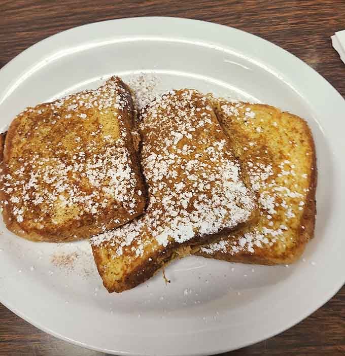 Golden, powdered-sugar-dusted French toast that makes every other breakfast feel like it owes you an apology.