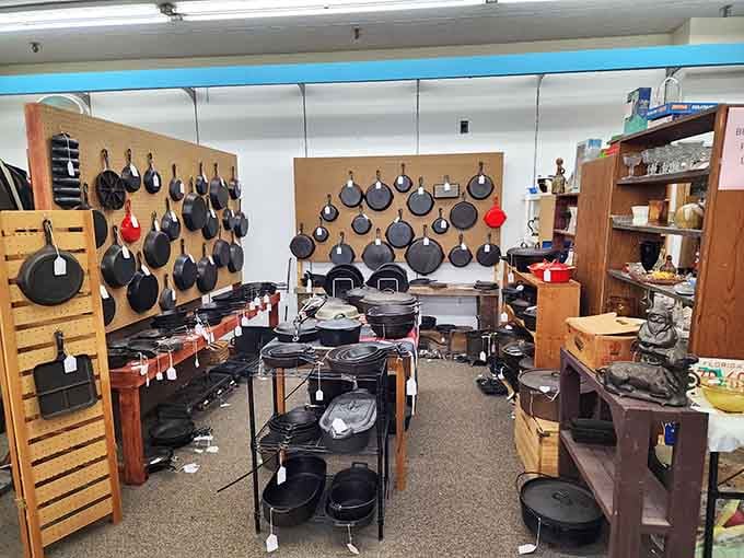 An entire wall of cast iron cookware that would make your grandmother weep with absolute joy.