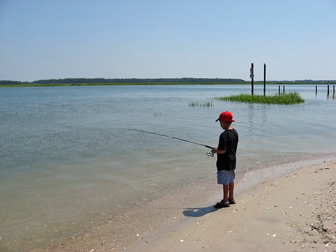 A kid with a fishing rod and a calm creek. Some vacation memories don't need a filter or a caption.
