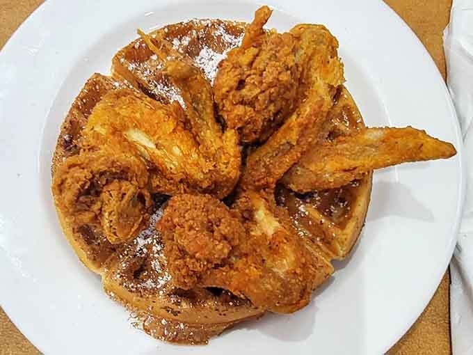 Crispy fried wings draped over a golden waffle, proof that some flavor combinations are simply meant to be.