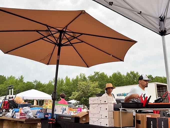Umbrellas provide shade while vendors showcase everything from electronics to household essentials under open skies.