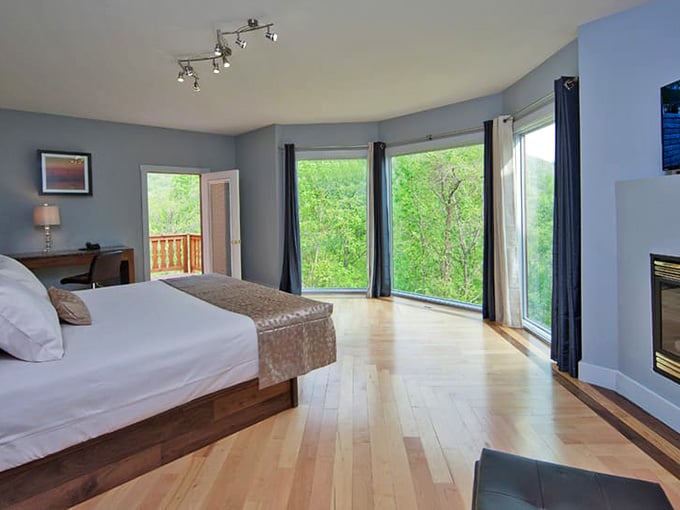 Floor-to-ceiling windows, a fireplace, and a balcony door that opens straight into the Blue Ridge Mountains.
